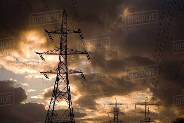 Electrical towers and a cloudy sky - Royalty-free Stock Photo | Dissolve