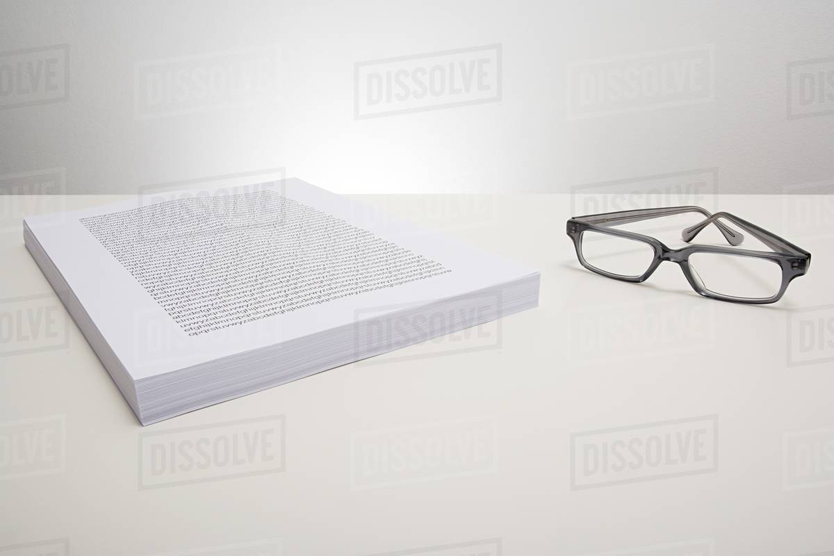 Eyeglasses and a stack of paper - Royalty-free Stock Photo | Dissolve
