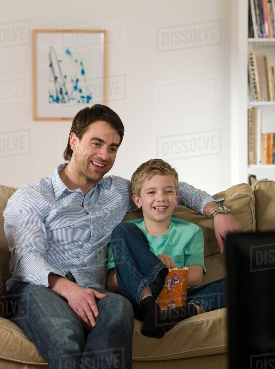 Father and son watching tv - Stock Photo - Dissolve
