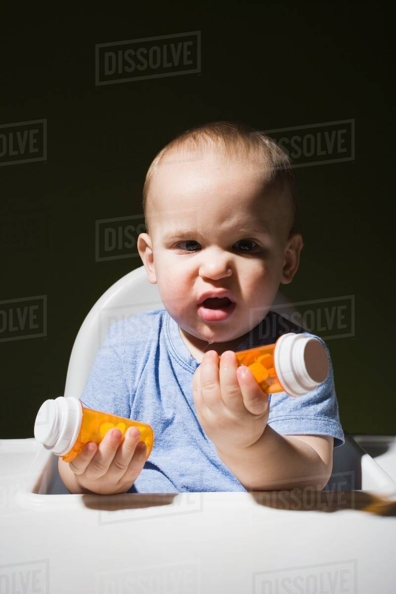 Baby with bottles of tablets - Royalty-free Stock Photo | Dissolve