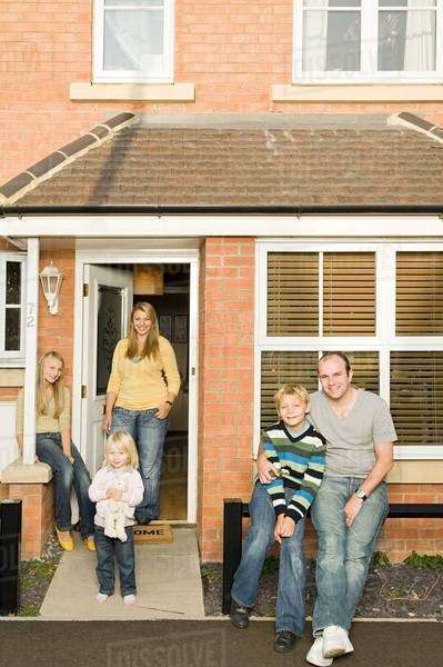 Family outside house - Stock Photo - Dissolve