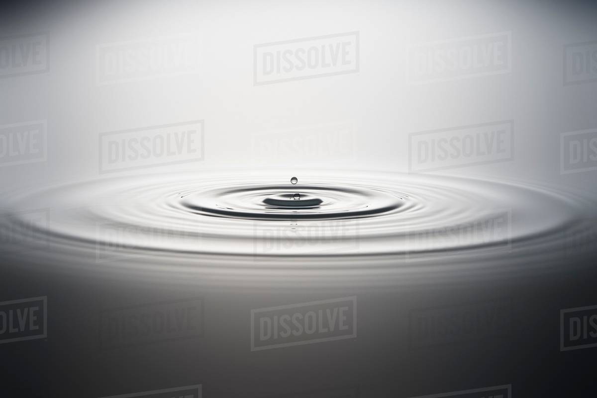 Water droplet falling into water - Royalty-free Stock Photo | Dissolve