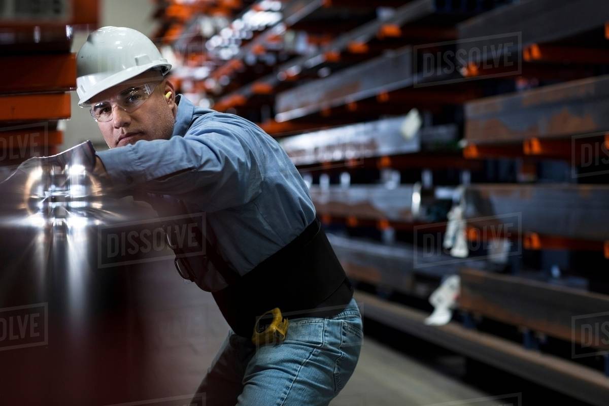 Worker using machinery in metal plant - Royalty-free Stock Photo | Dissolve
