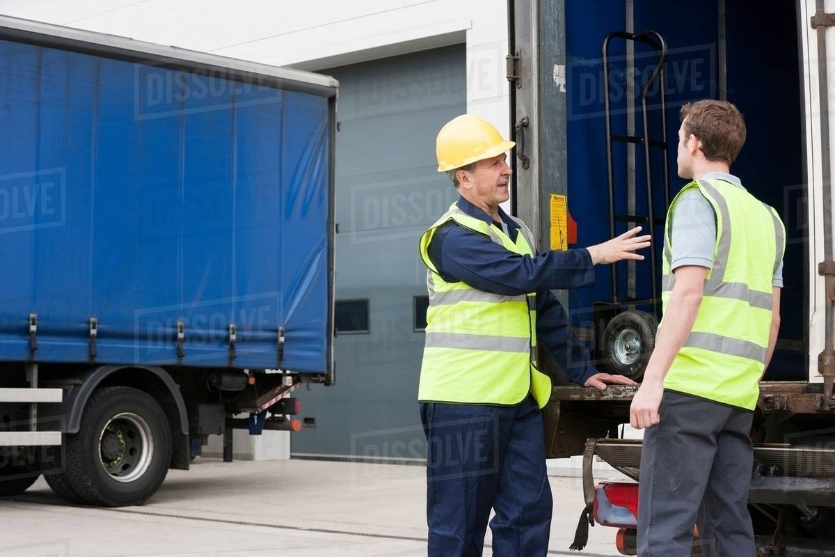 Two men loading truck - Stock Photo - Dissolve