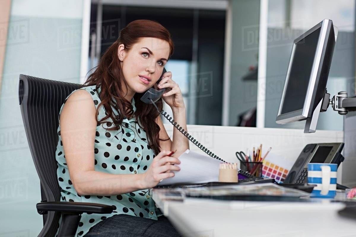 Woman on landline phone - Stock Photo - Dissolve