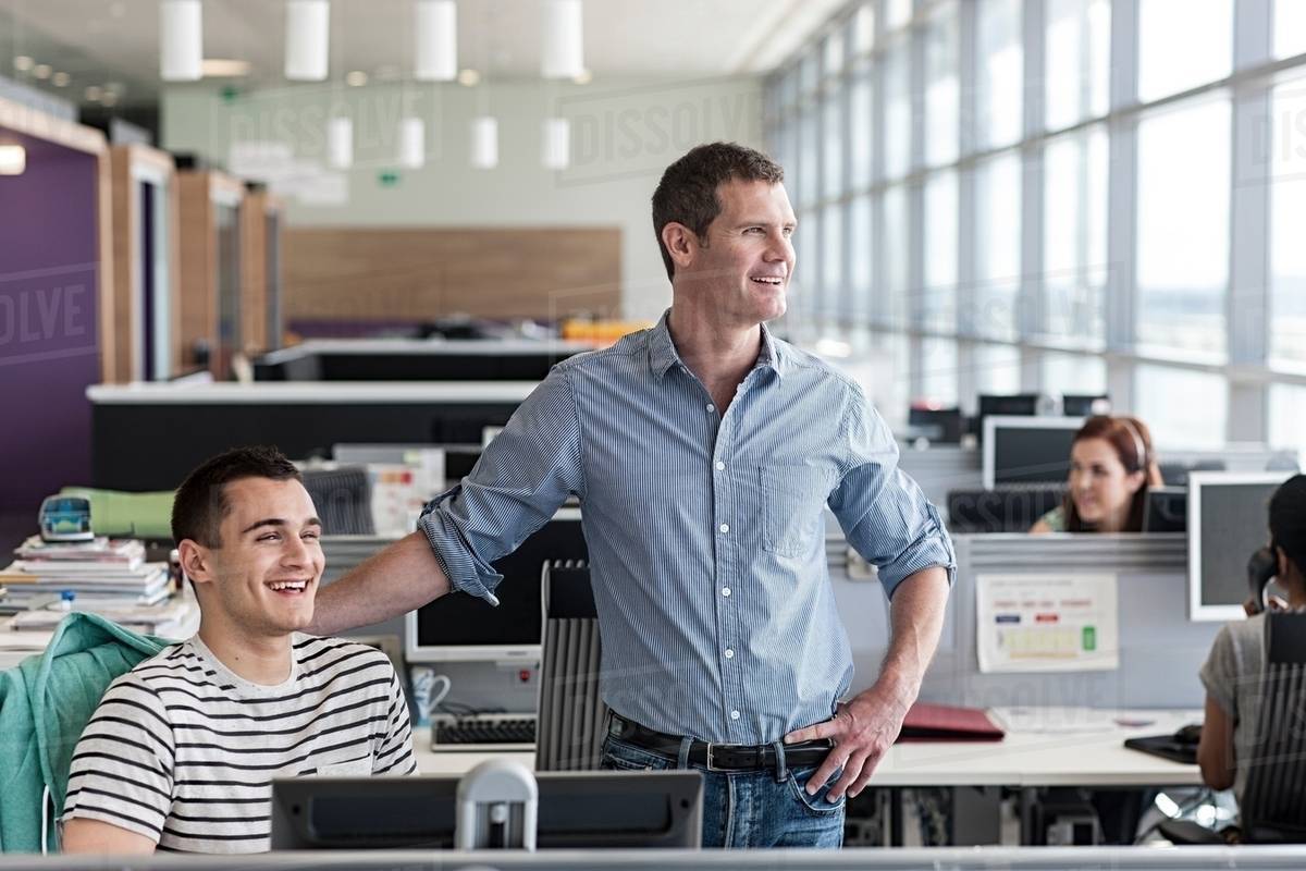 Two colleagues in office interior - Stock Photo - Dissolve