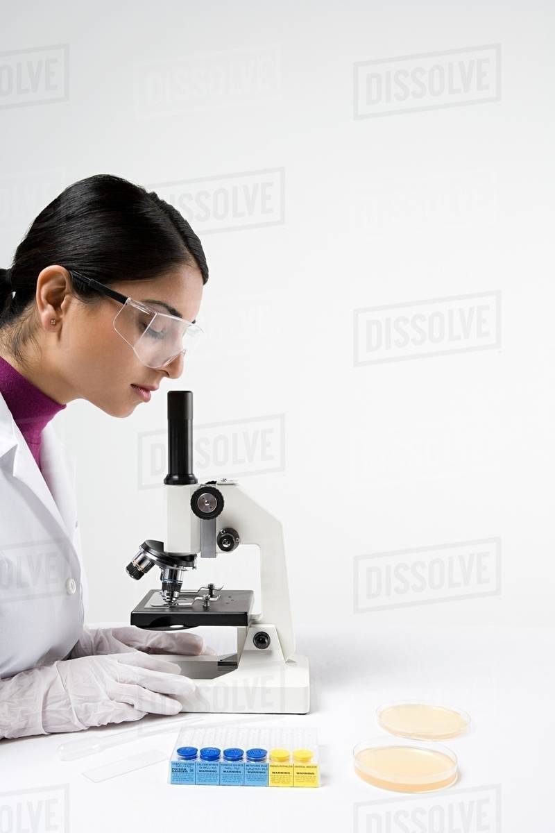 Scientist with microscope - Stock Photo - Dissolve