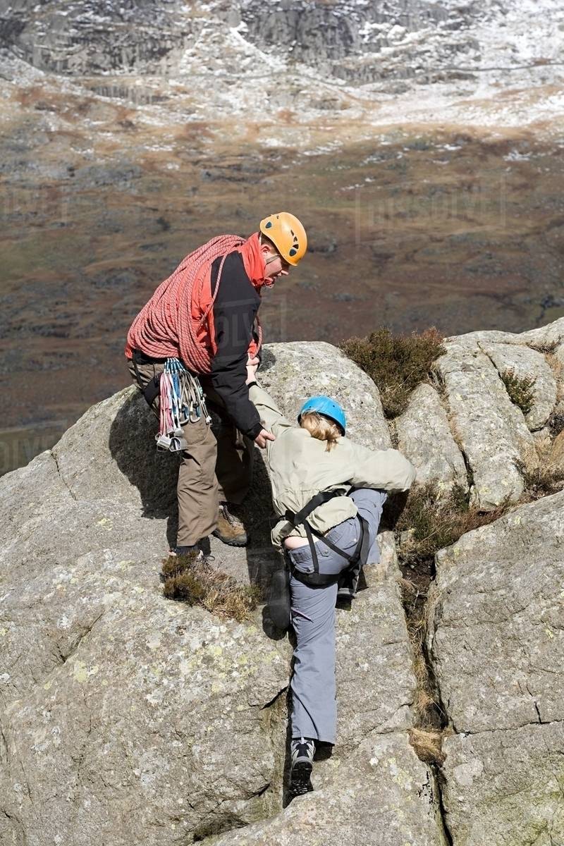 A man giving a man a helping hand - Stock Photo - Dissolve