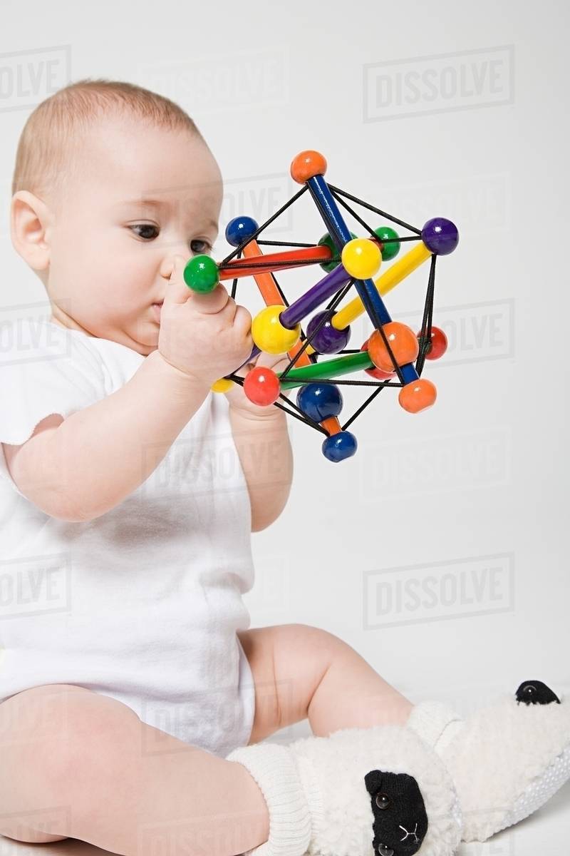 A baby boy holding a toy - Royalty-free Stock Photo | Dissolve