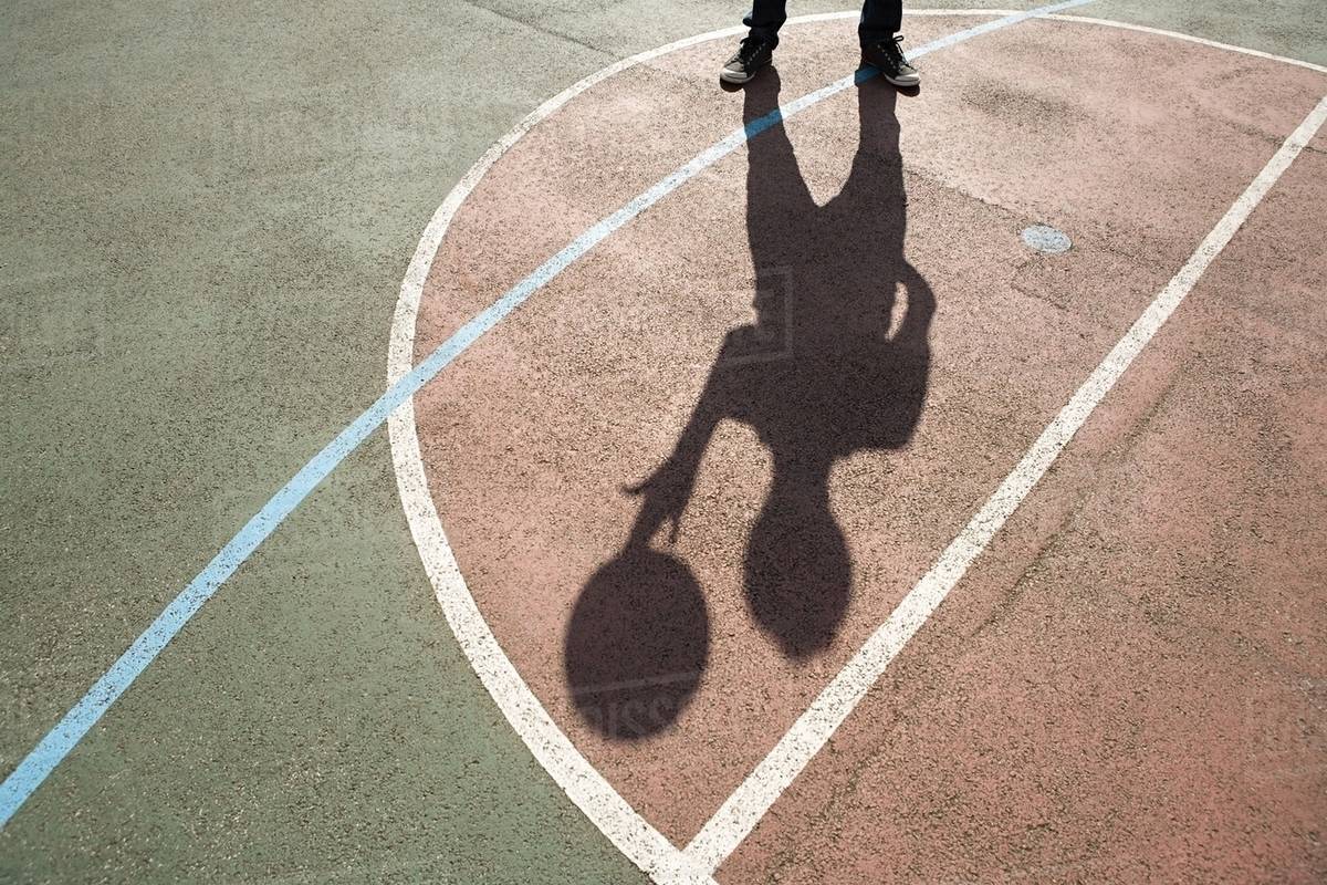 Shadow of person with basketball - Stock Photo - Dissolve