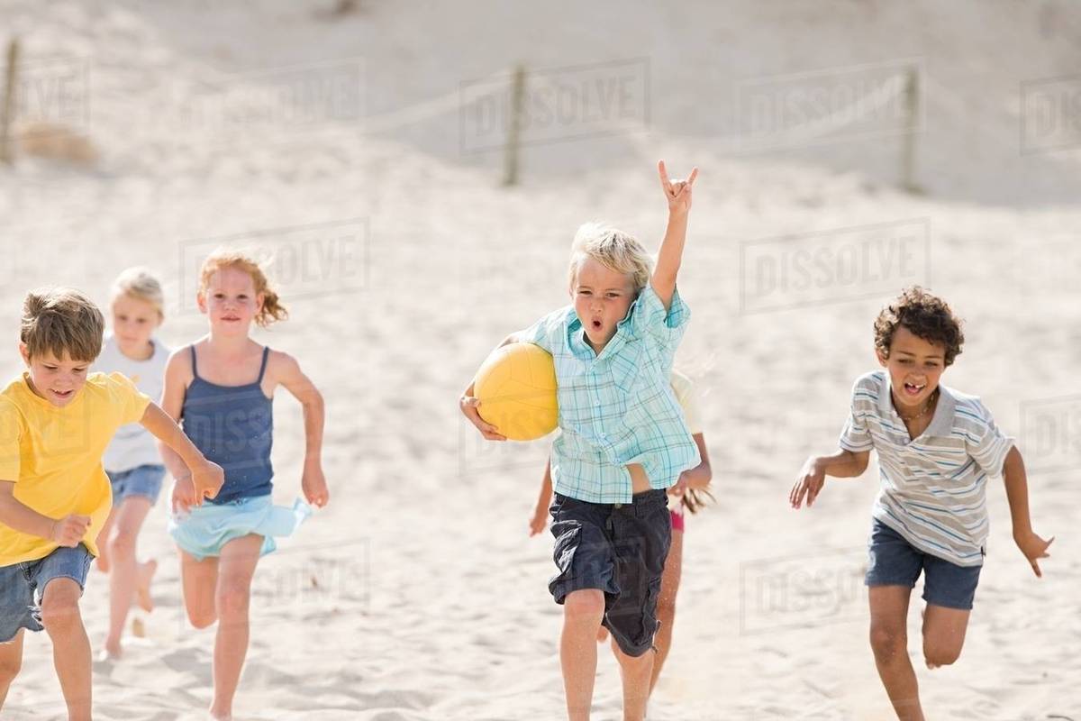 Children running across beach - Royalty-free Stock Photo | Dissolve