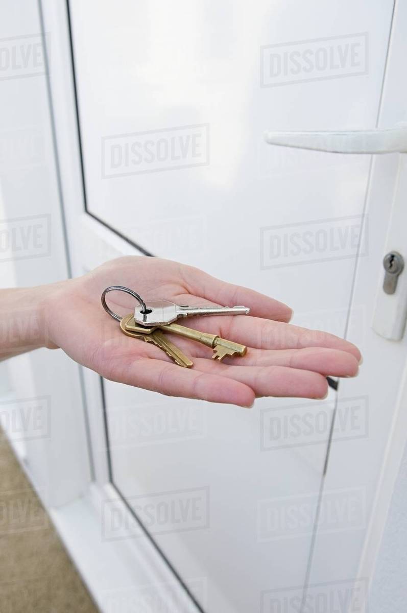 Person holding keys - Stock Photo - Dissolve