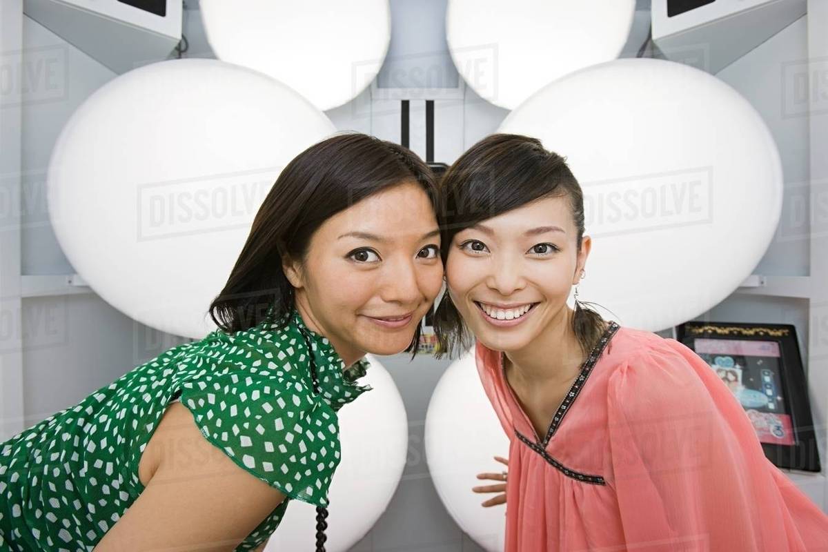 Friends in a photo booth - Royalty-free Stock Photo | Dissolve