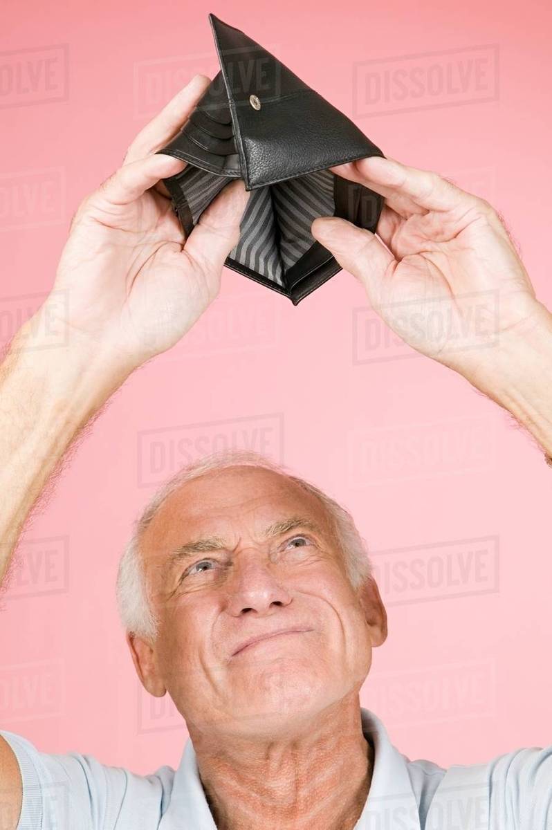 Man looking in empty wallet - Royalty-free Stock Photo | Dissolve