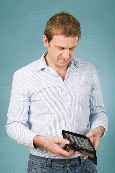 Man looking in wallet - Royalty-free Stock Photo | Dissolve