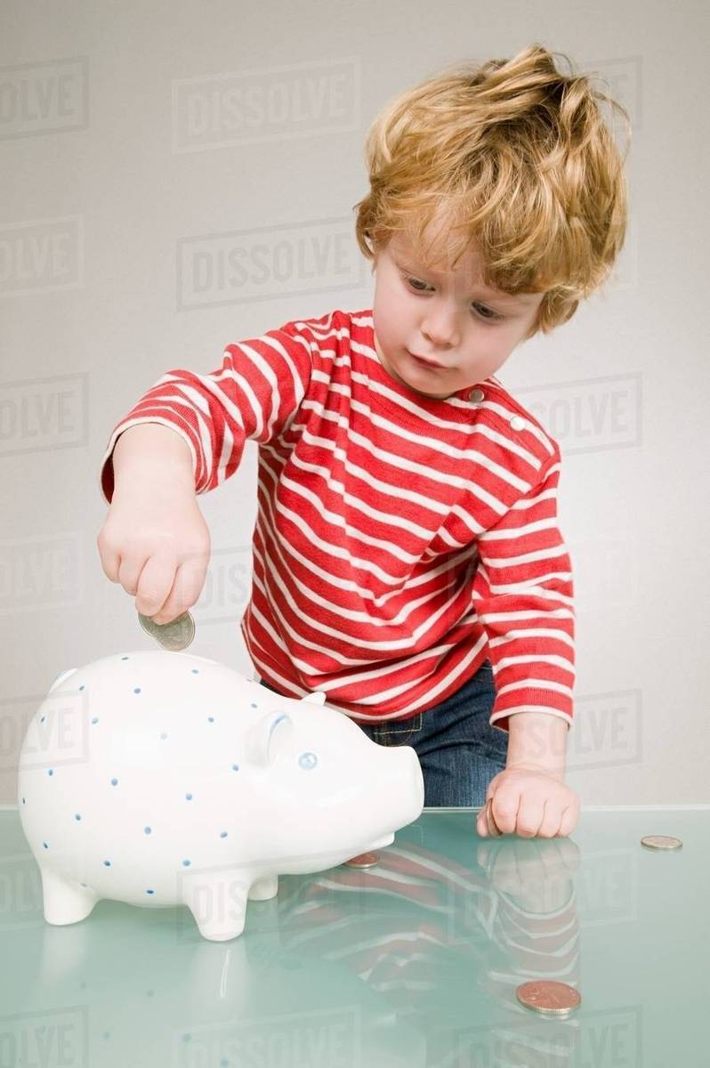 Boy with piggy bank - Royalty-free Stock Photo | Dissolve