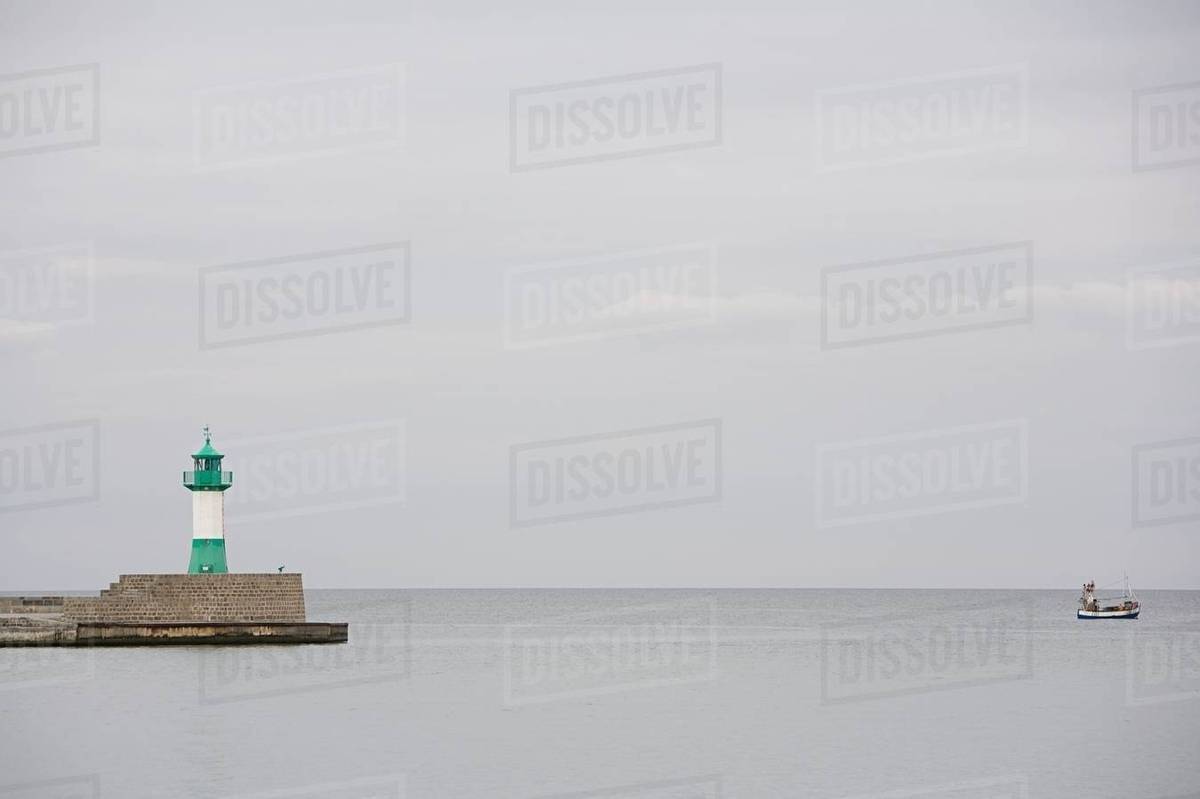 Lighthouse and boat on sea - Royalty-free Stock Photo | Dissolve
