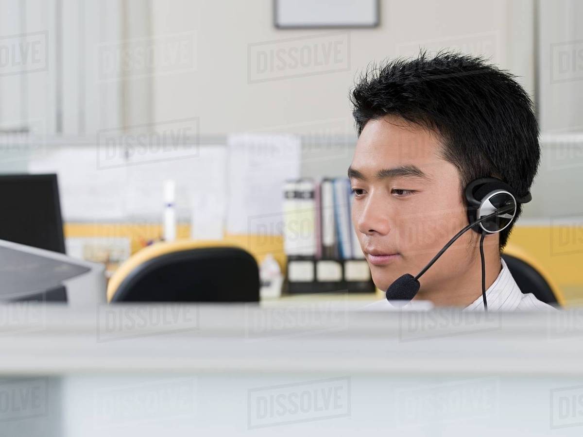 Office worker with headset - Stock Photo - Dissolve