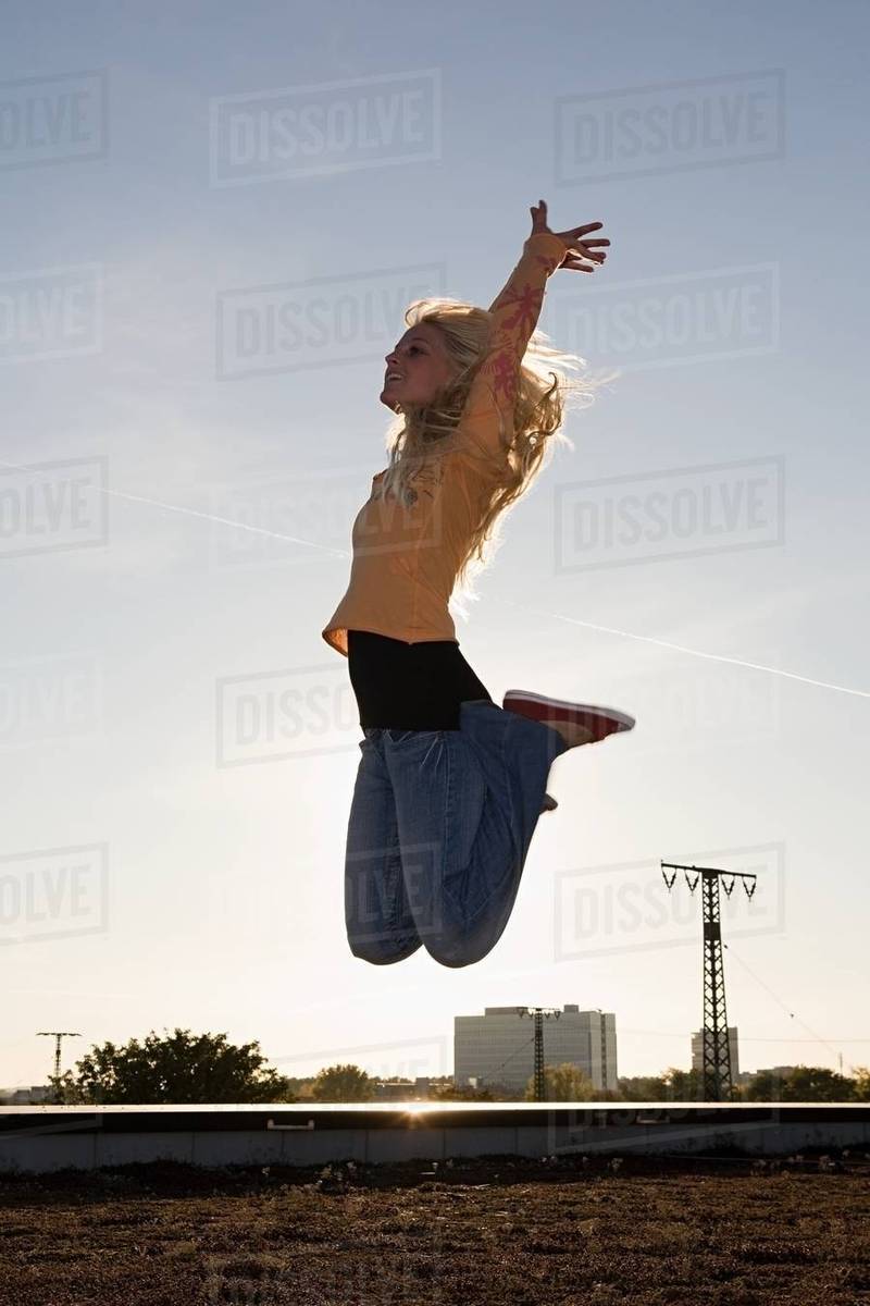 Young woman jumping for joy - Royalty-free Stock Photo | Dissolve