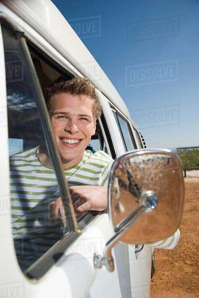 A young man in a camper van - Stock Photo - Dissolve