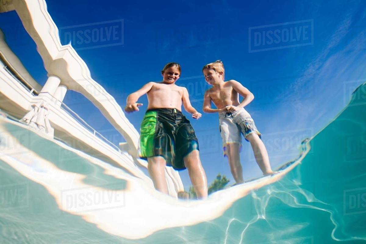 Boys by swimming pool - Royalty-free Stock Photo | Dissolve