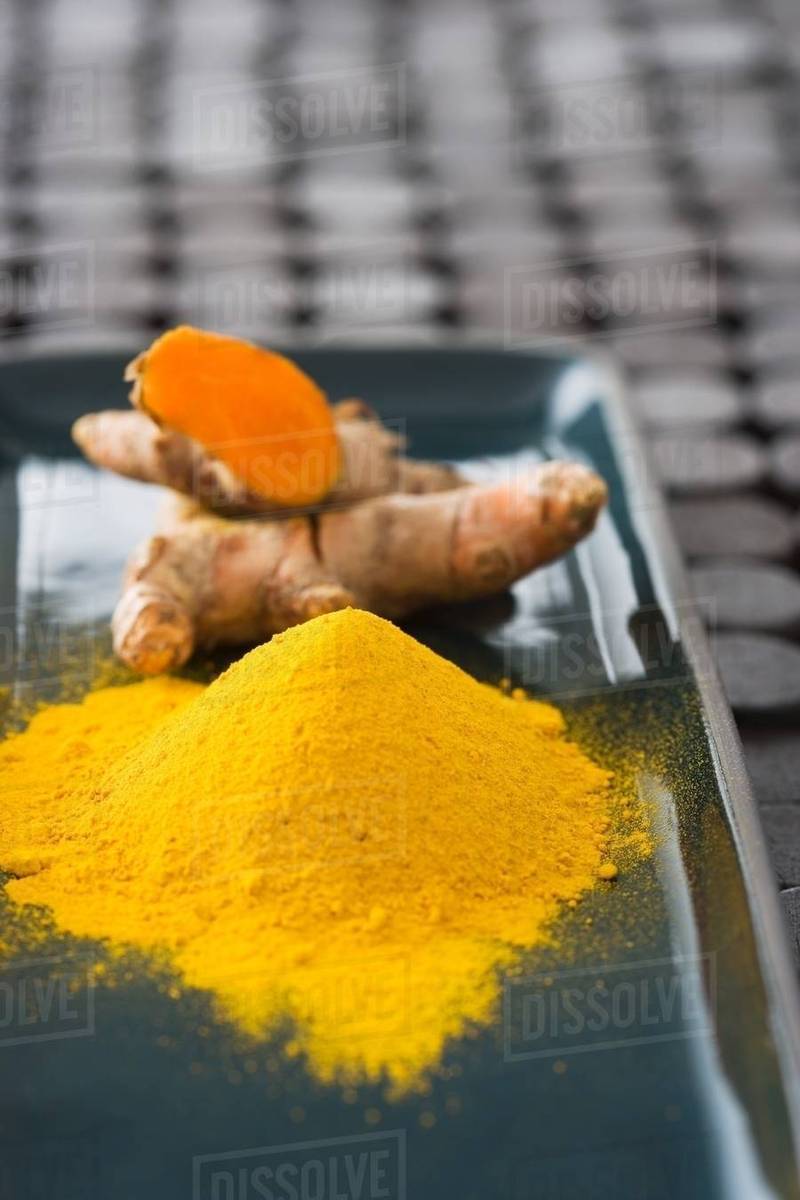Tumeric powder and fresh tumeric - Royalty-free Stock Photo | Dissolve