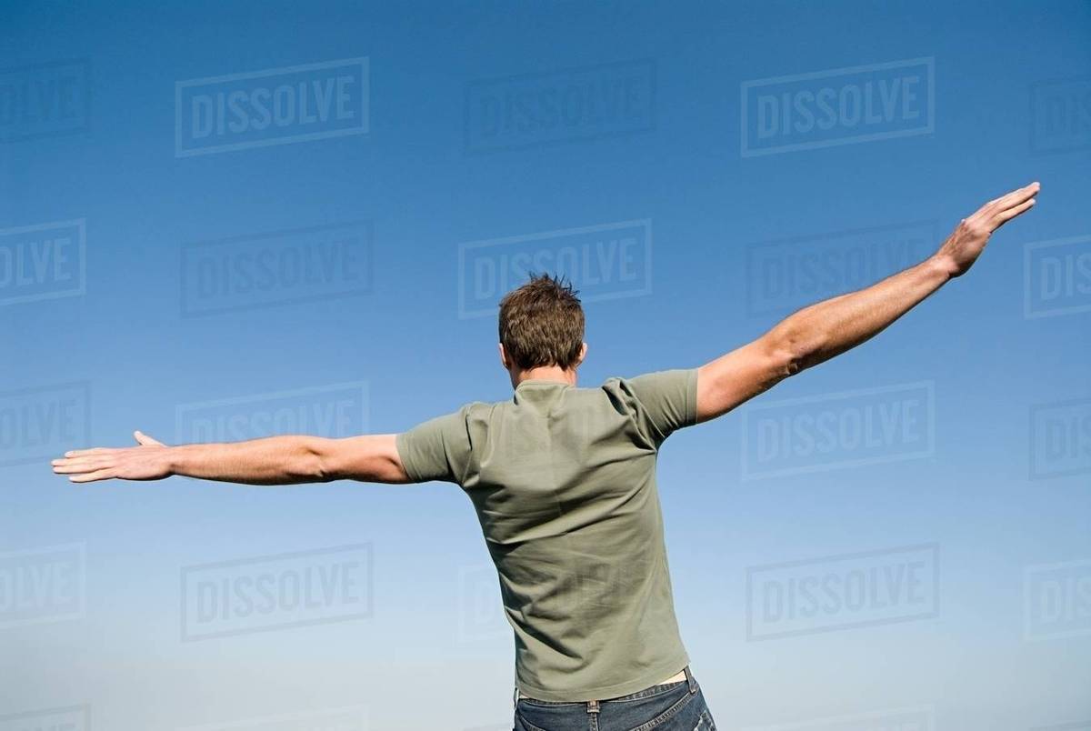 Man standing with arms open - Royalty-free Stock Photo | Dissolve