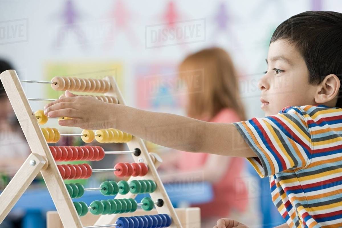 A boy counting on abacus - Royalty-free Stock Photo | Dissolve