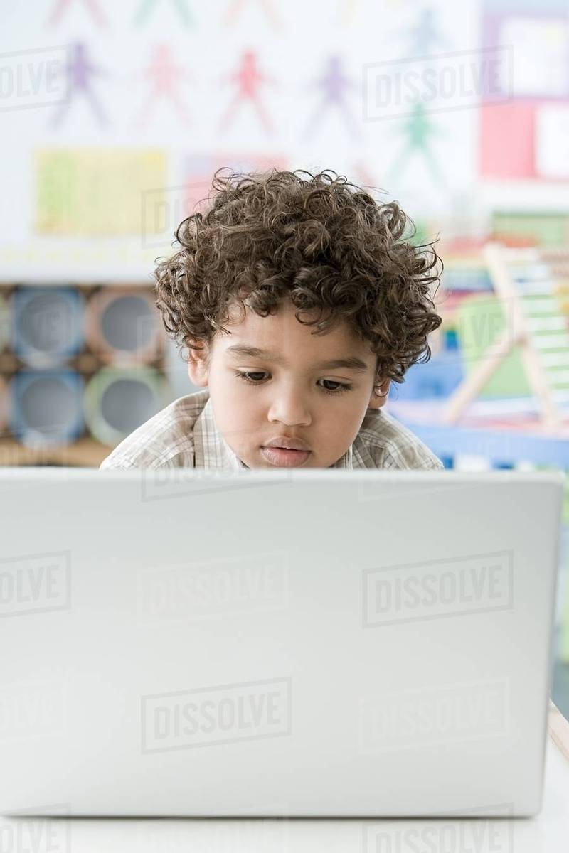 Boy using laptop - Royalty-free Stock Photo | Dissolve
