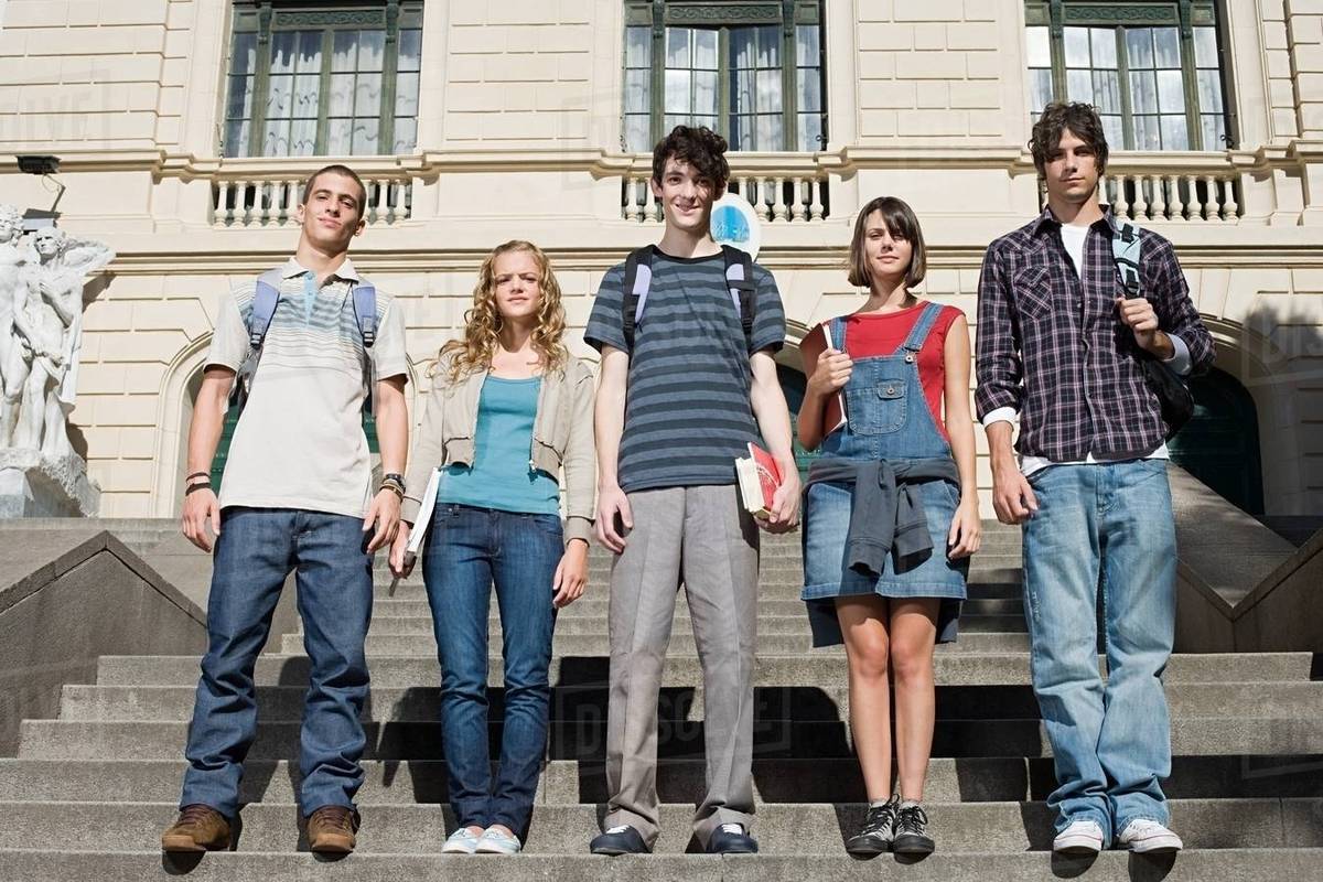 Teenagers standing on college steps - Royalty-free Stock Photo | Dissolve