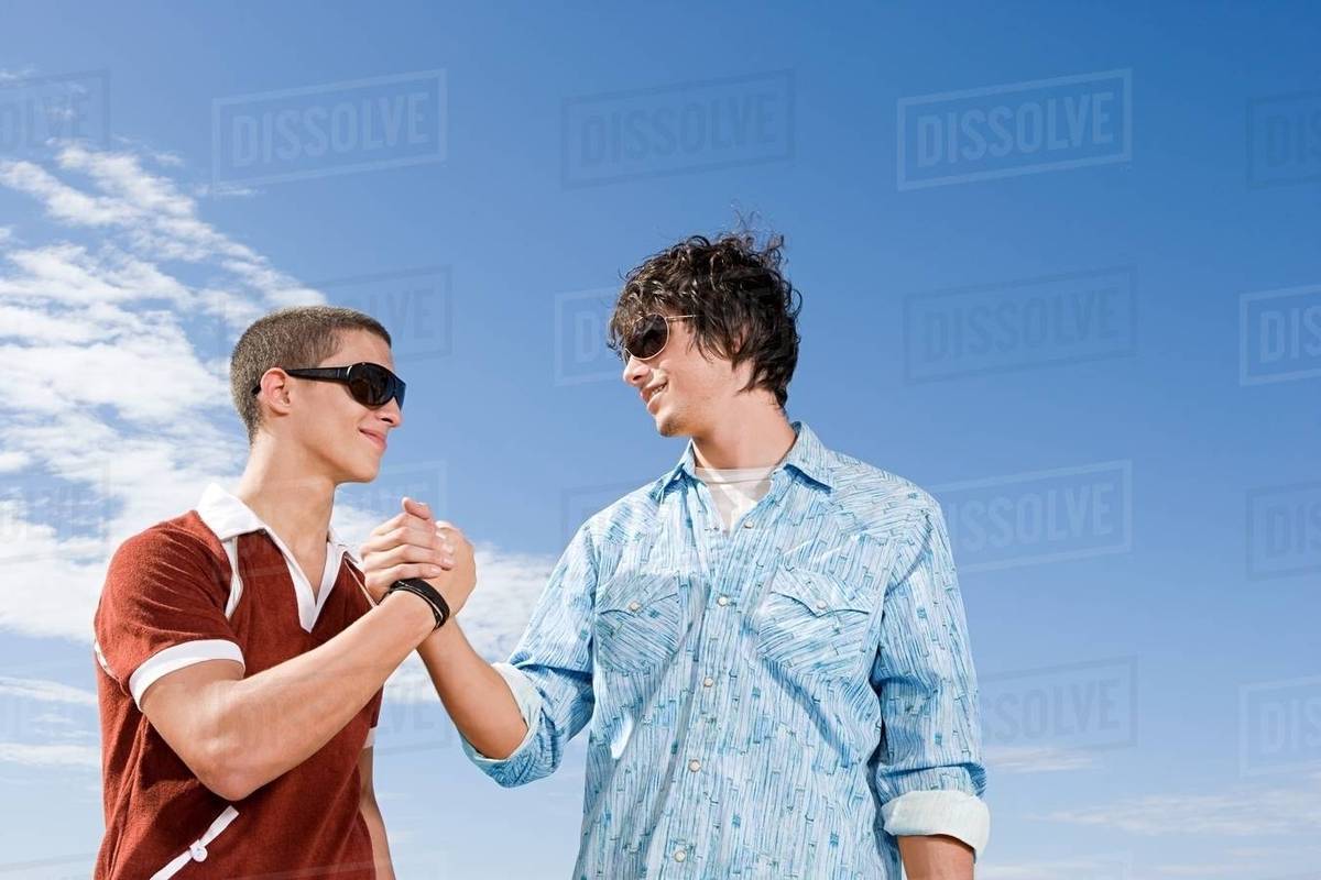 Teenage boys shaking hands - Royalty-free Stock Photo | Dissolve
