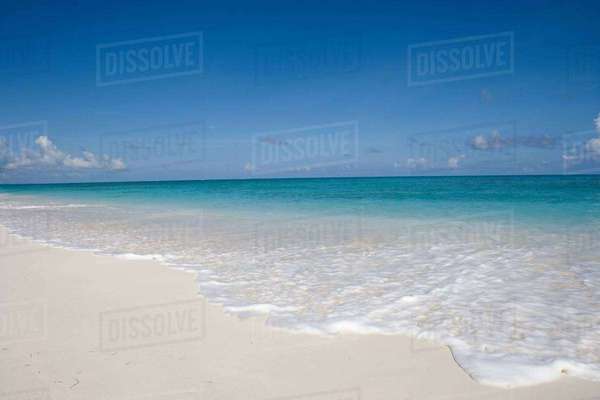 Waves on sandy beach. - Royalty-free Stock Photo | Dissolve