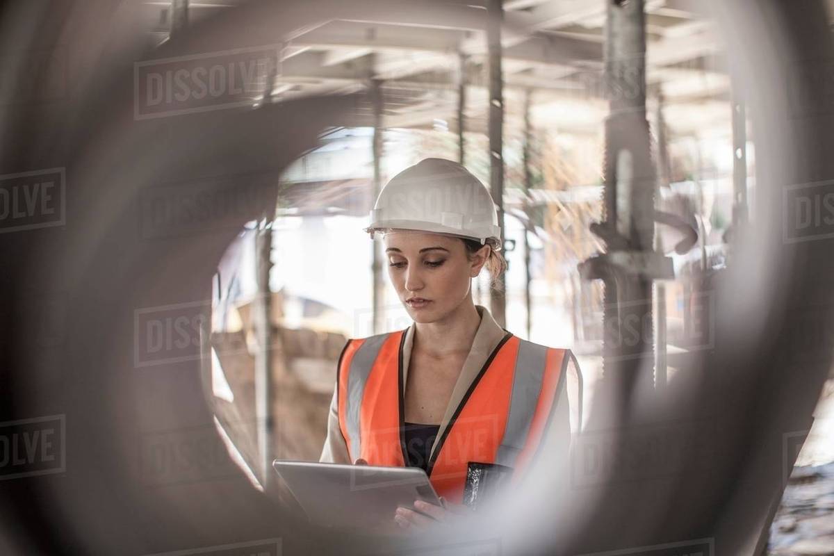 Female builder using digital tablet on construction site - Stock Photo ...
