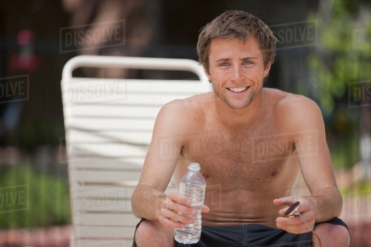 Man drinking water by swimming pool - Stock Photo - Dissolve