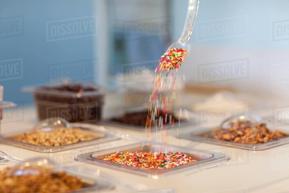 Sprinkles pouring from spoon in display - Royalty-free Stock Photo ...