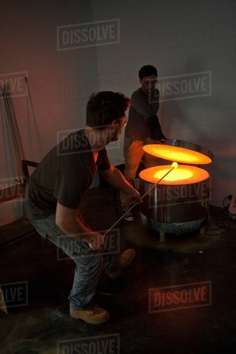 Two men working in glass factory - Stock Photo - Dissolve