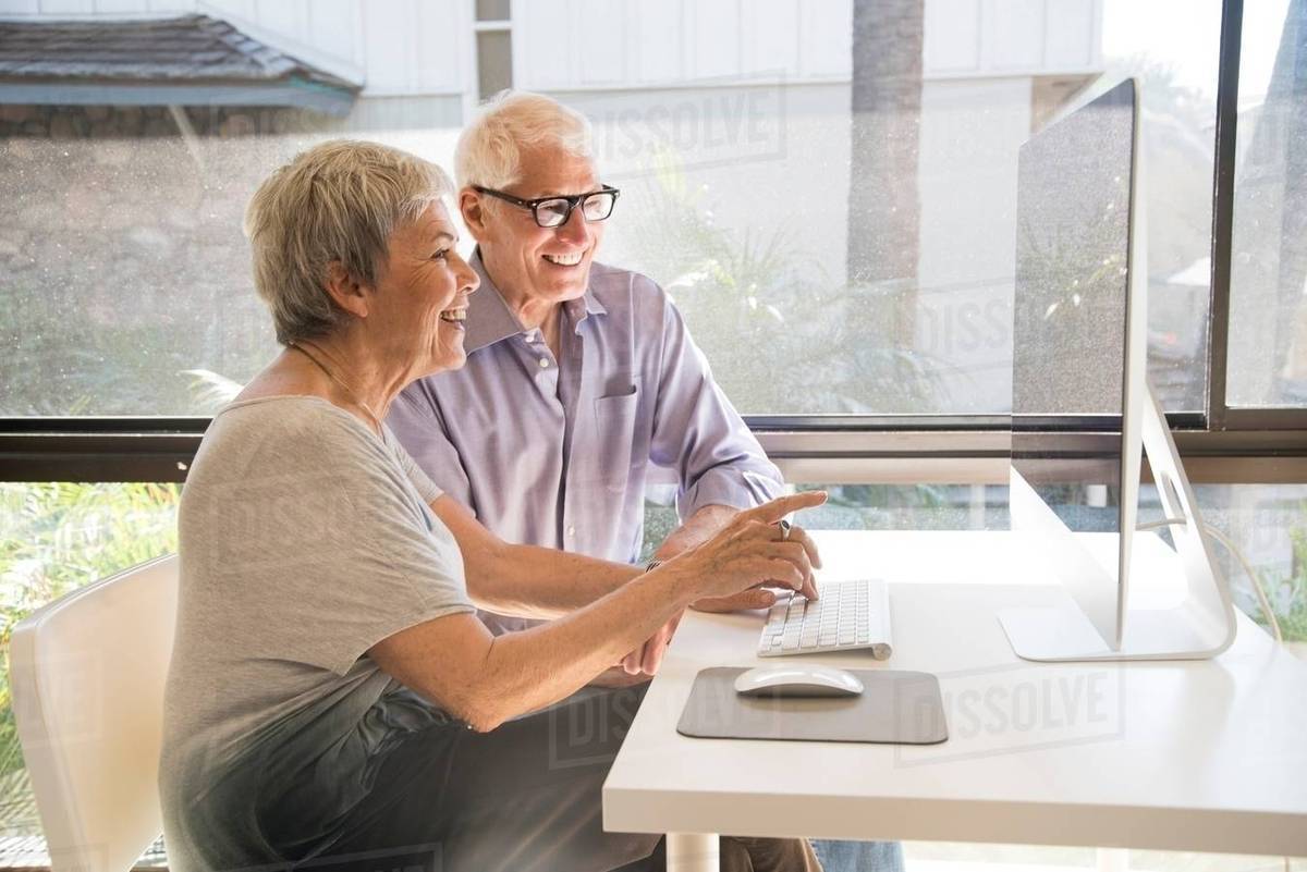 Senior couple using computer, looking at computer screen - Royalty-free ...