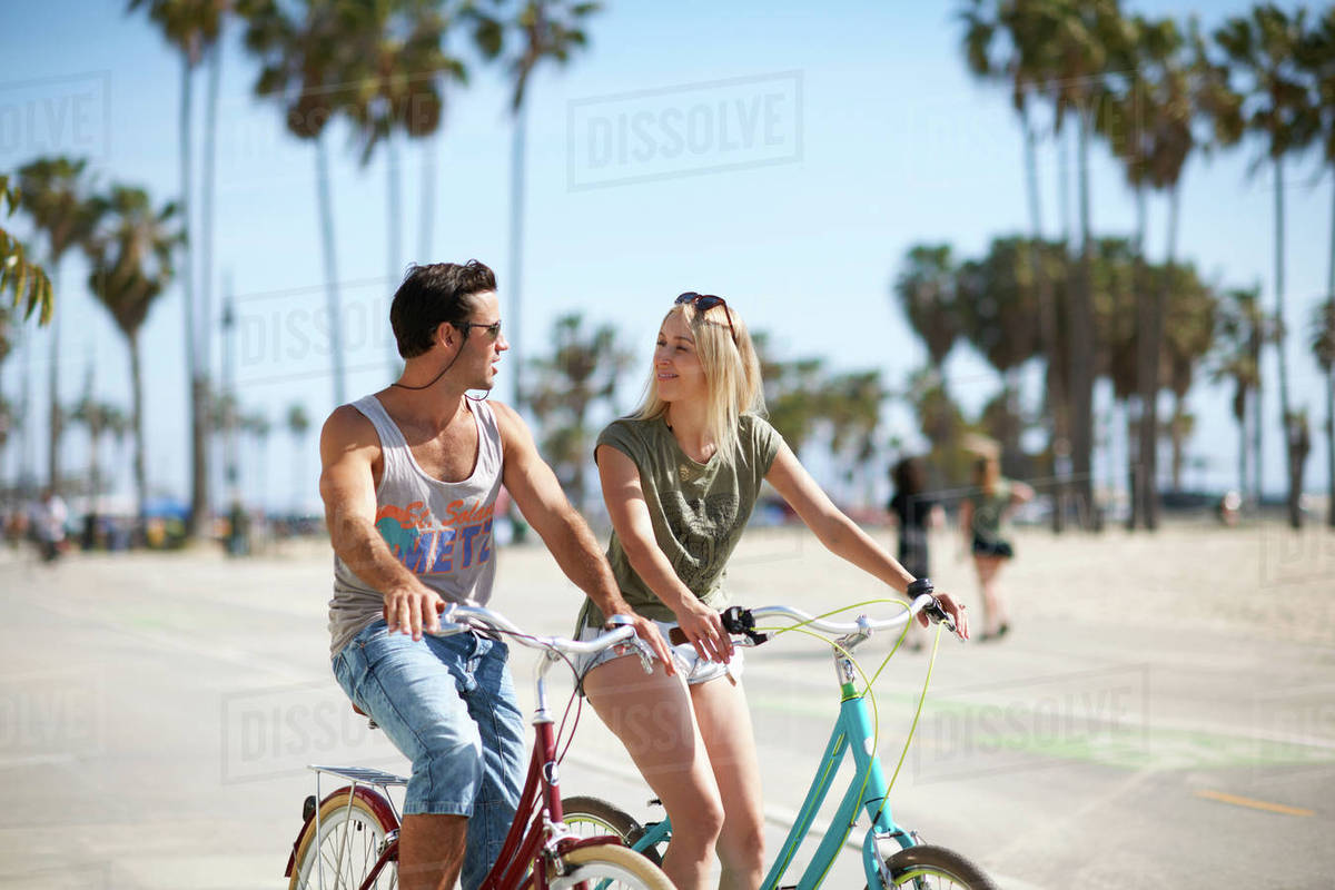 Couple cycling together at Venice Beach, Los Angeles, California, USA ...