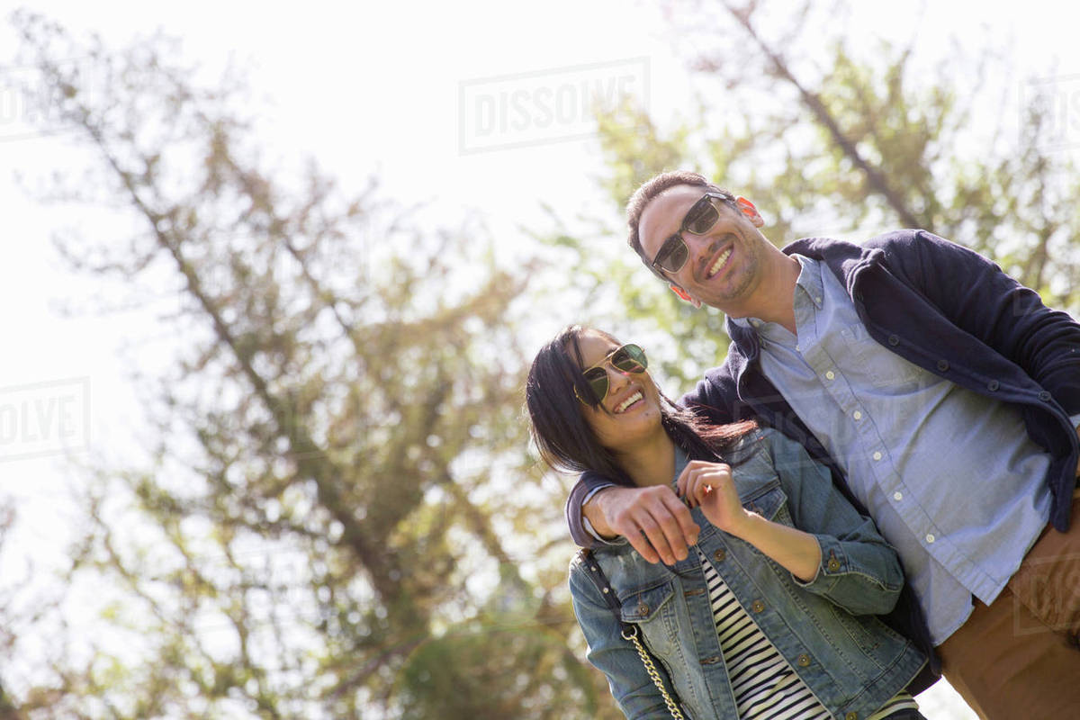 Low angle view of couple wearing sunglasses - Royalty-free Stock Photo ...
