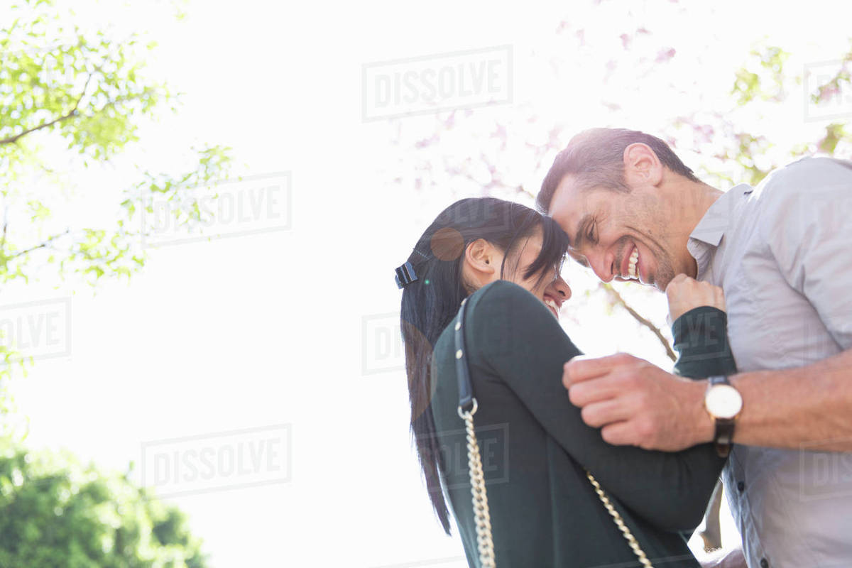 Low angle view of couple face to face smiling - Royalty-free Stock ...