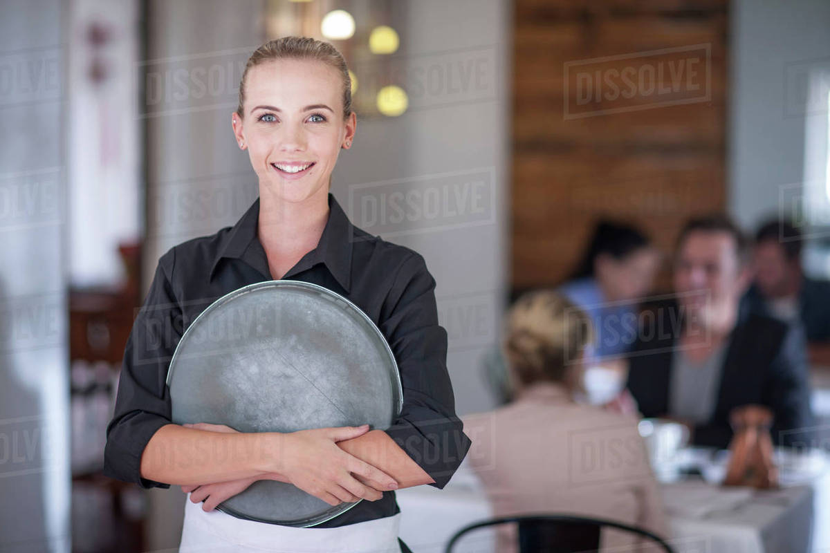 Waitress with serving tray in busy restaurant - Royalty-free Stock ...