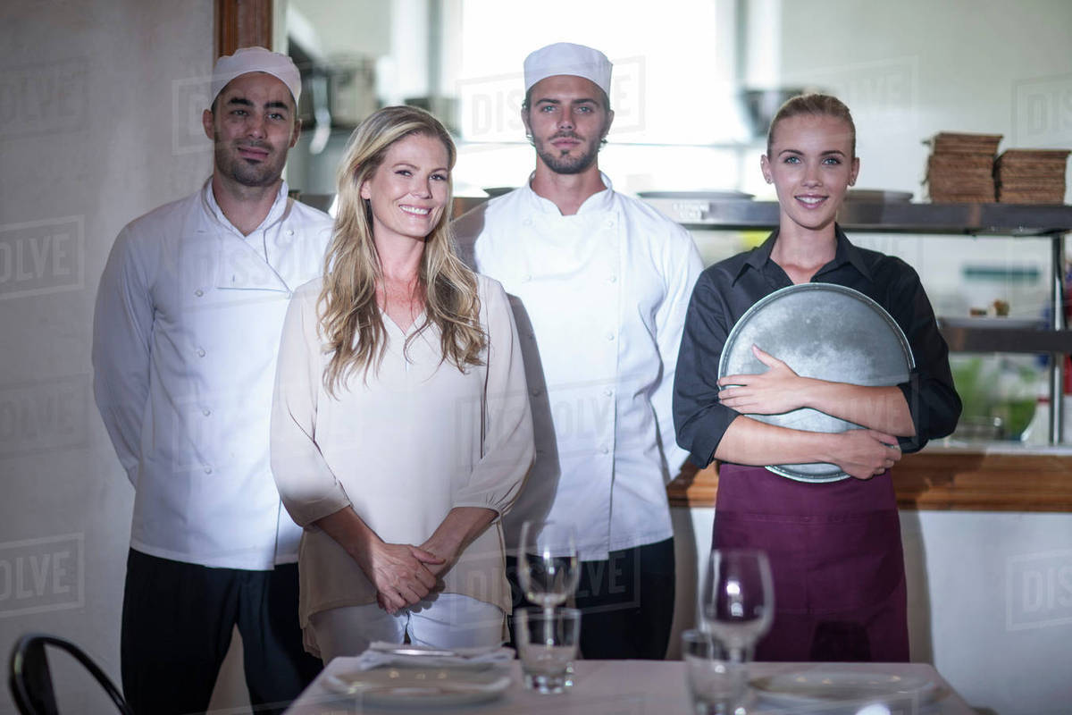 Chefs and waitresses in restaurant - Royalty-free Stock Photo | Dissolve