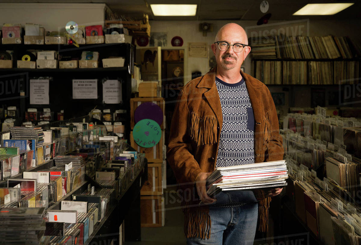 Portrait of mature man in record shop, holding records - Royalty-free ...