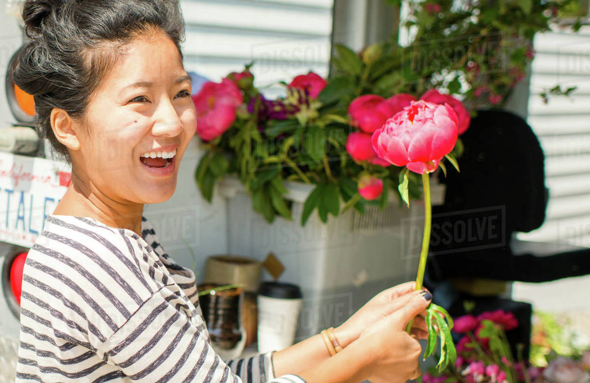 Happy florist working with flowers - Royalty-free Stock Photo | Dissolve