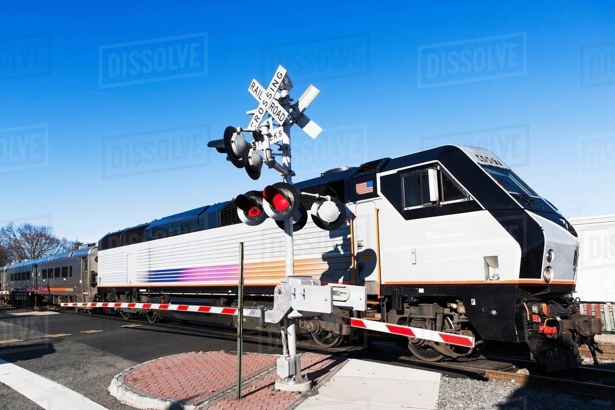 Passenger train passing level crossing - Royalty-free Stock Photo ...