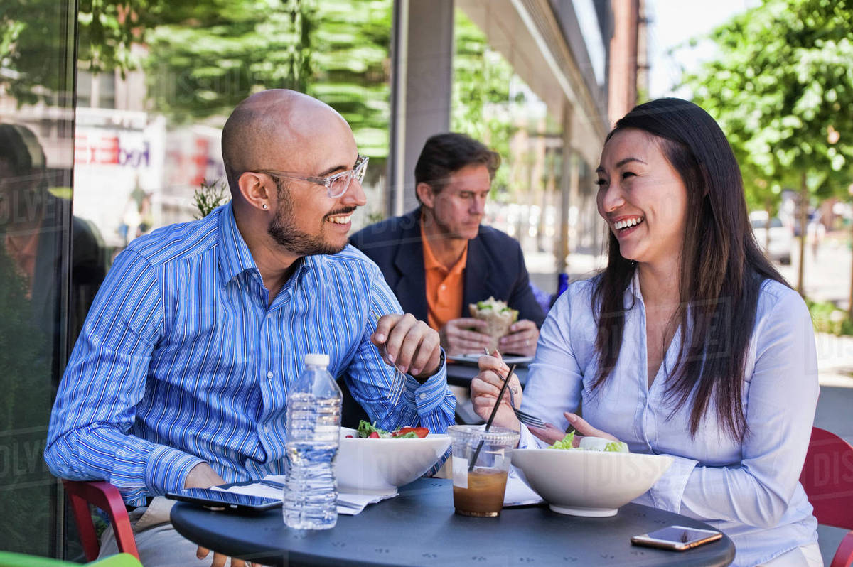Man and woman having lunch outside cafe - Royalty-free Stock Photo ...