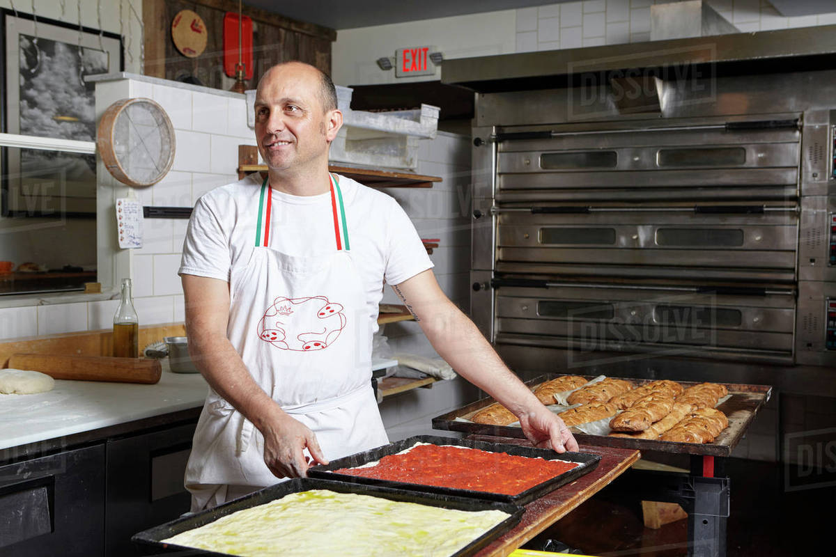 Baker working in bakery - Royalty-free Stock Photo | Dissolve