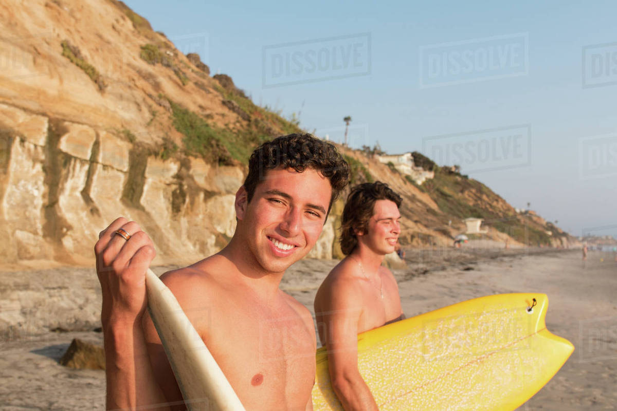 Two young men on beach, holding surfboards - Royalty-free Stock Photo ...