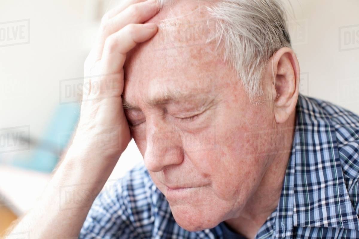 Senior man with head in hands - Royalty-free Stock Photo | Dissolve