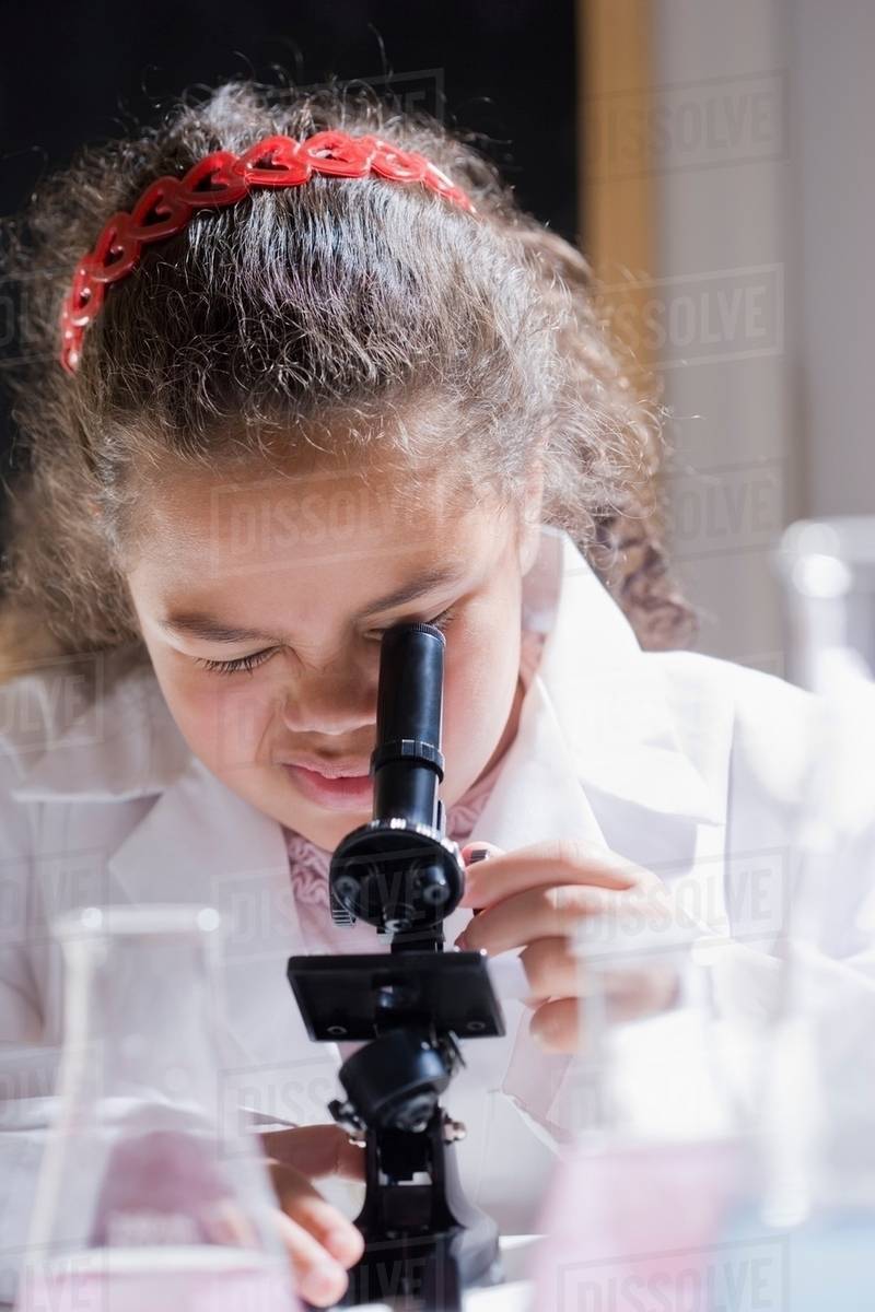Girl using microscope - Royalty-free Stock Photo | Dissolve
